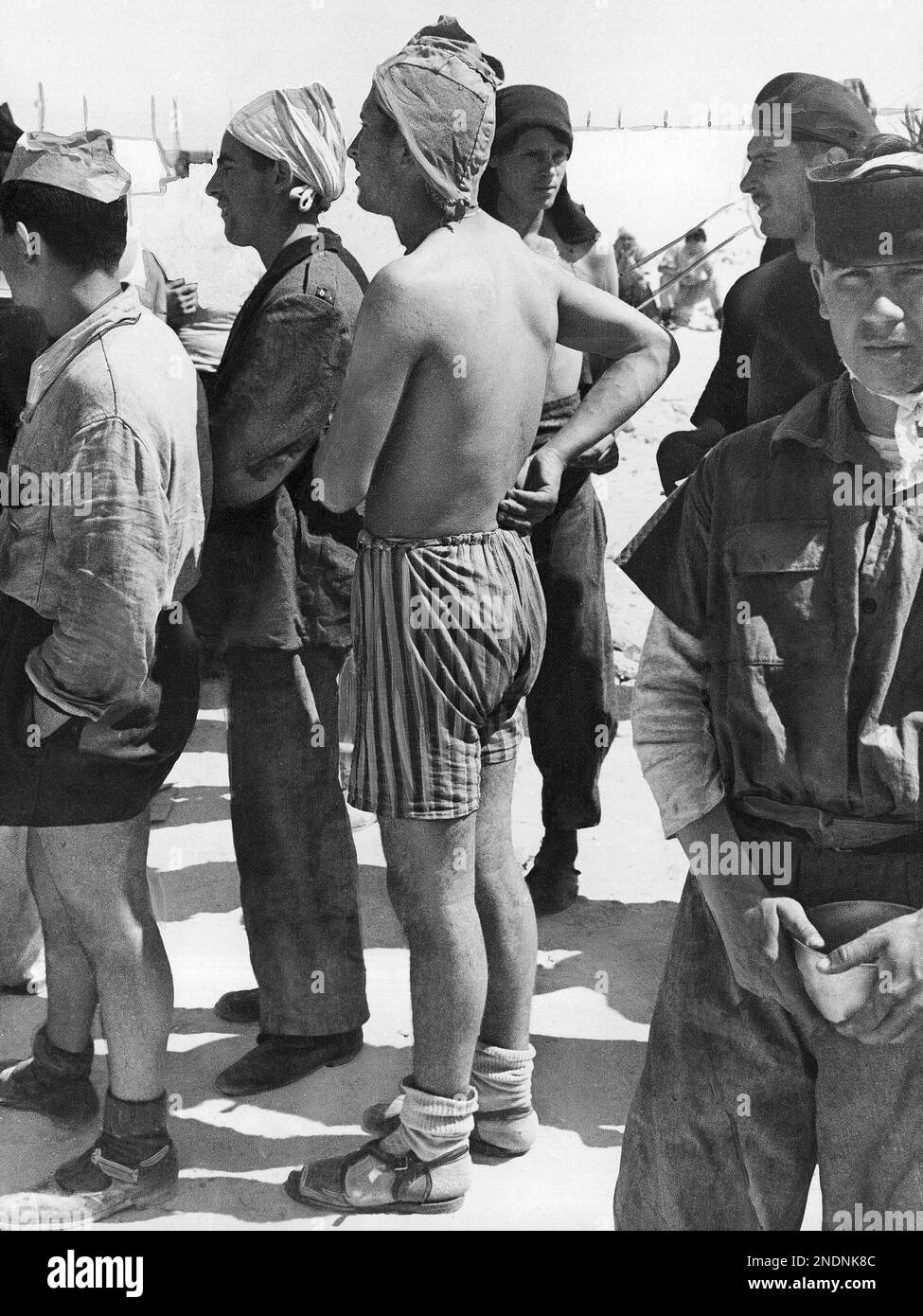 This Italian prisoner wore striped shorts, shoes and a cloth sun hat as ...