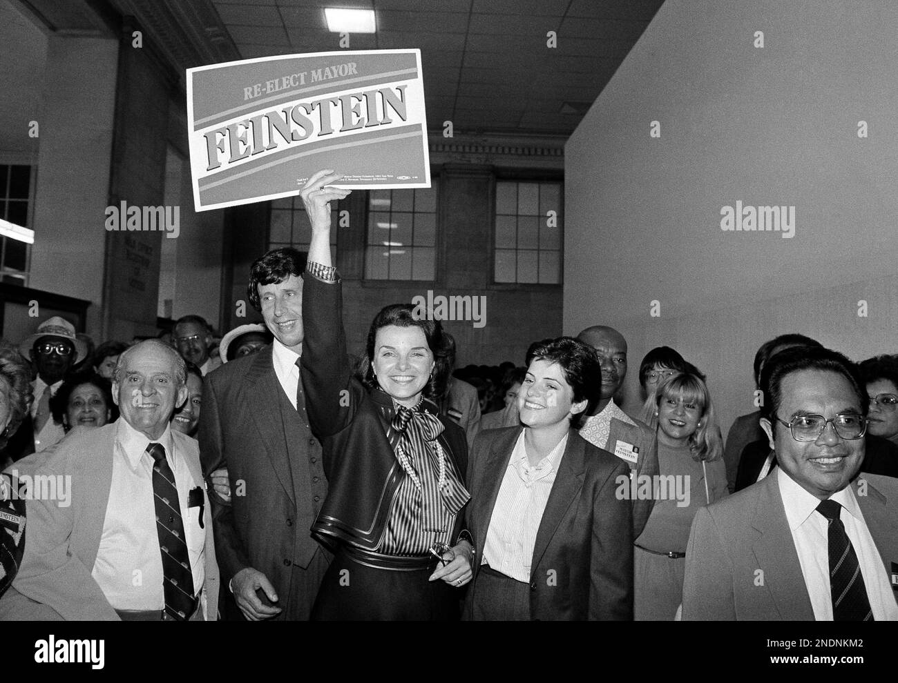 San Francisco Mayor Dianne Feinstein holds a campaign poster high as ...