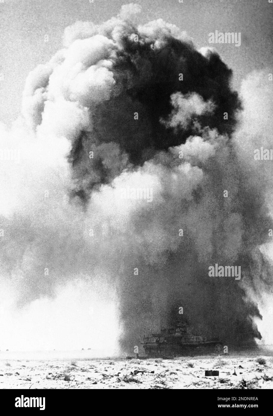 Clouds of smoke rise skyward after a British bomb had scored a direct ...