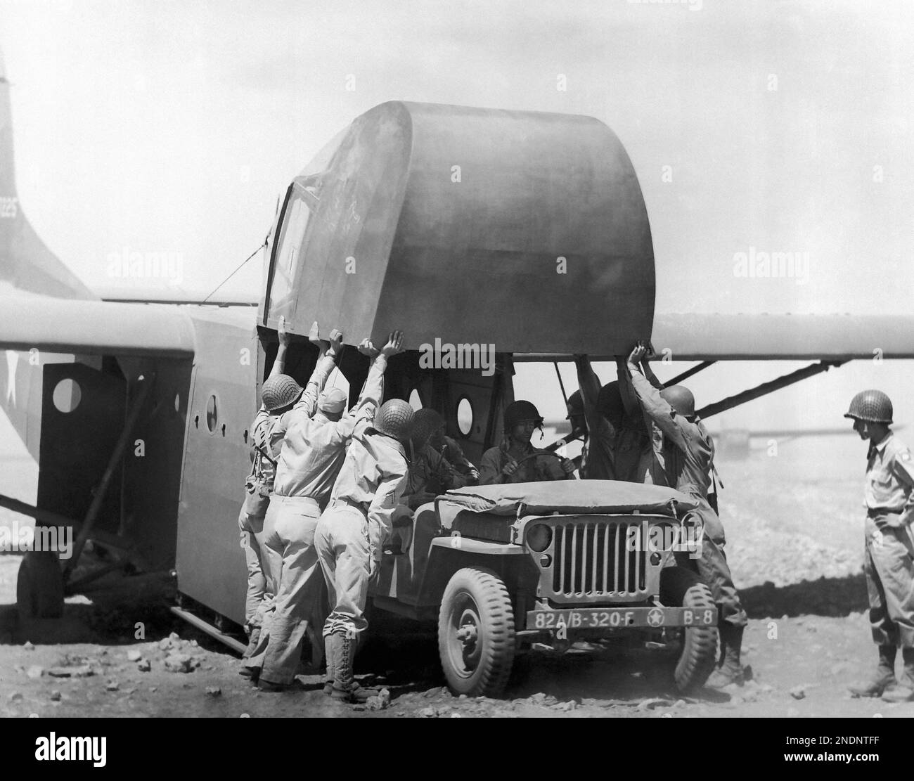 Airborne troops quickly unload a jeep from a glider, July 19, 1943 ...
