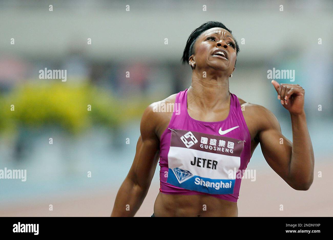 Carmelita Jeter of the United States reacts as she crosses the ...
