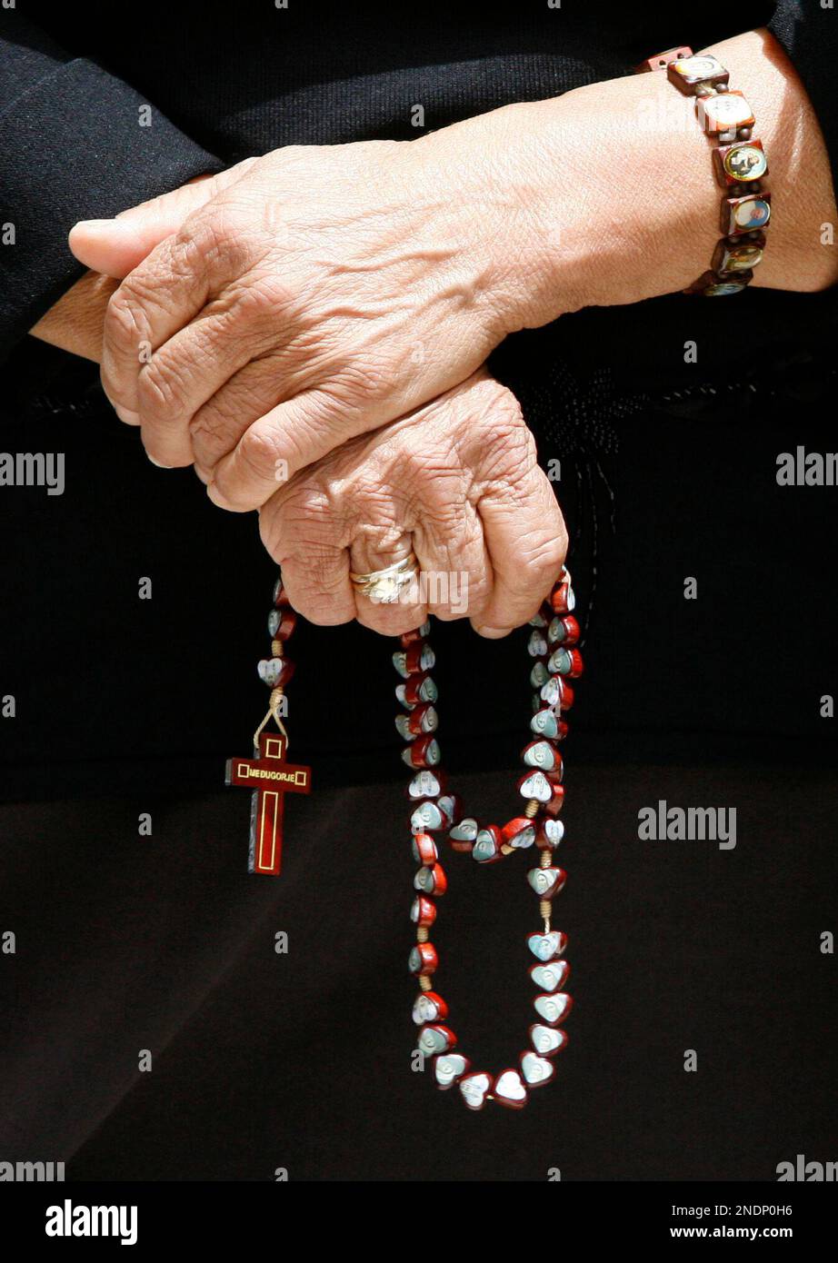 In this photo made May 9, 2010 an elderly Maronite woman holds a rosary ...