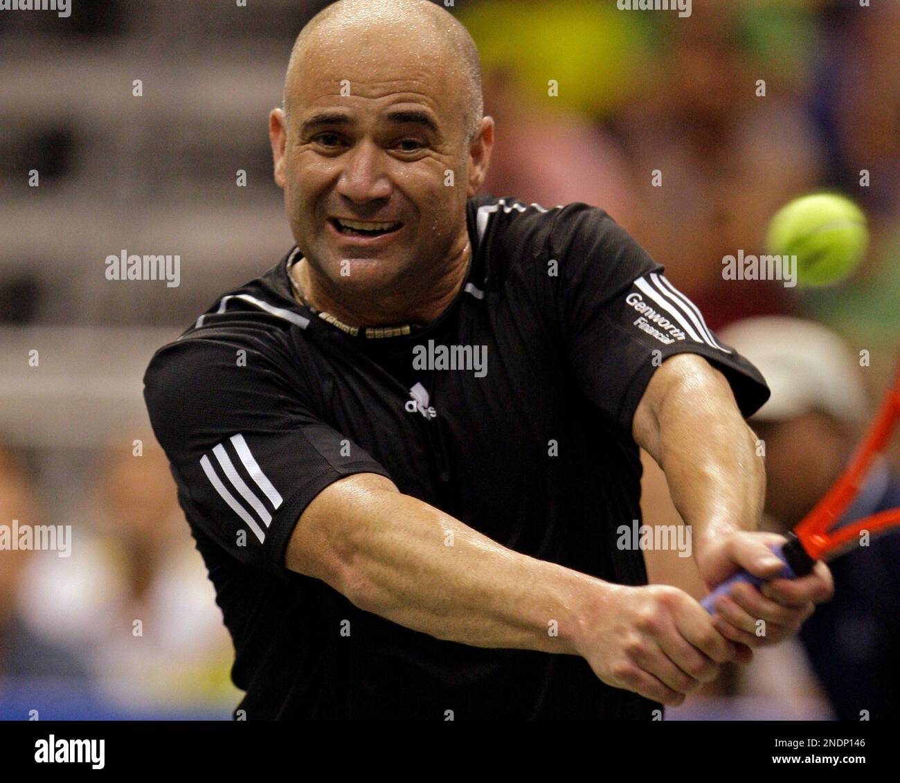 Retired US tennis champion Andre Agassi returns the ball to Pete ...