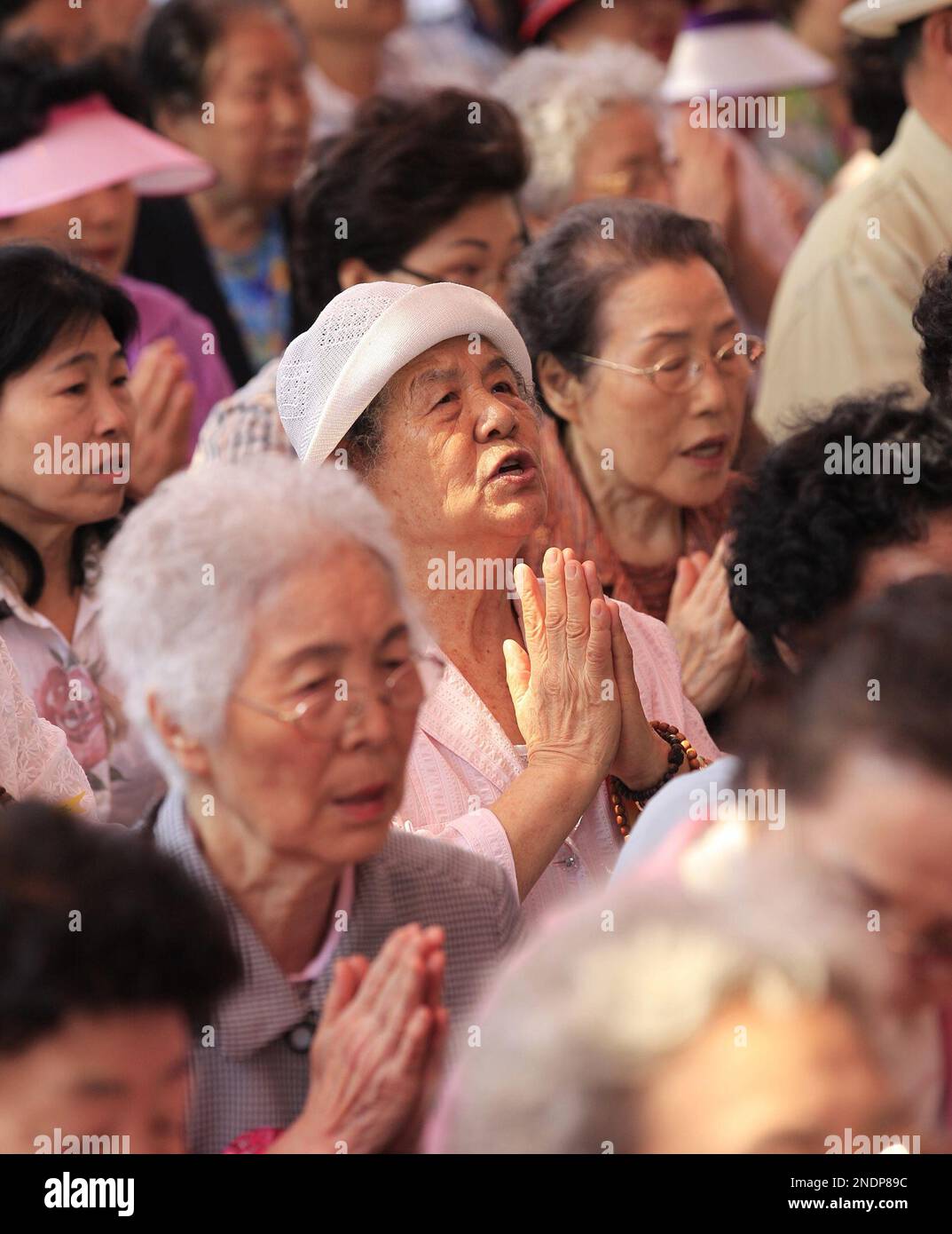 The South Korean faithful pray during a service to celebrate the 2 ...