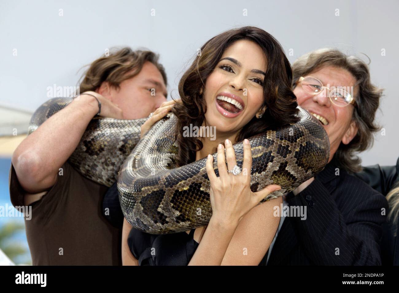 Actress Mallika Sherawat poses with a snake during a photo call for ...