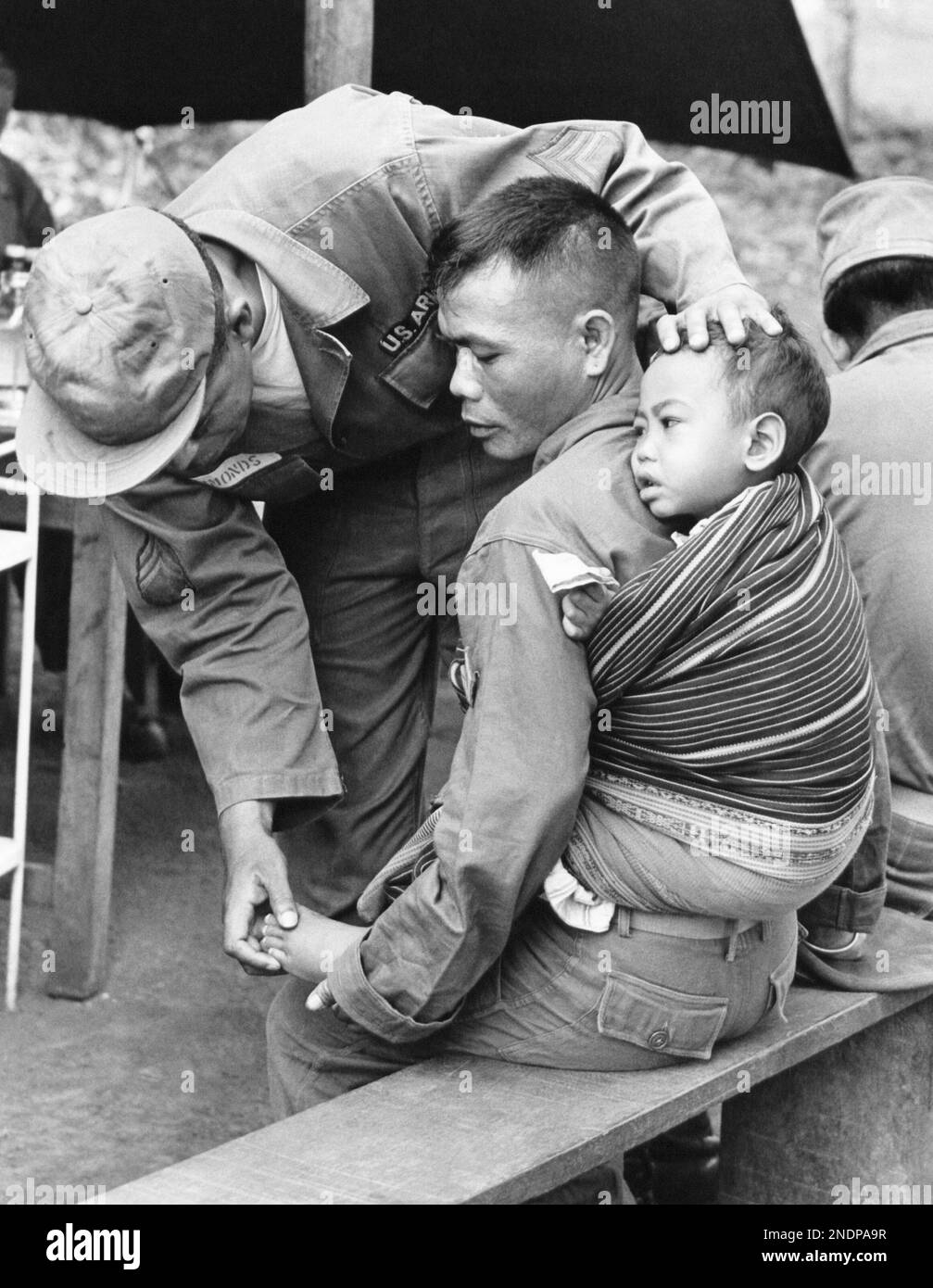 A little child of the Radai tribe is treated by U.S. medic at a ...