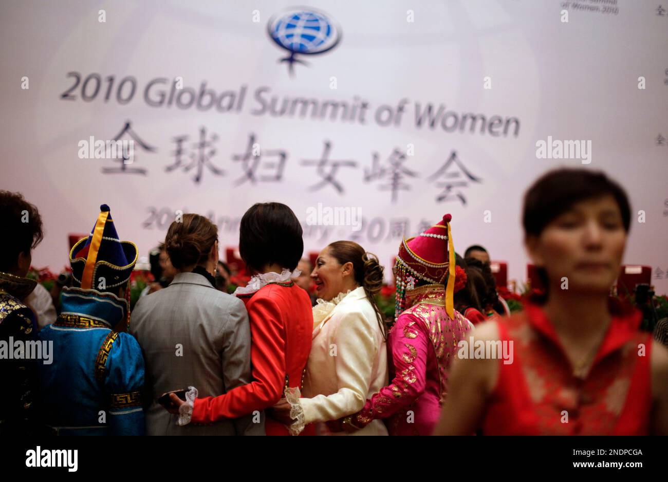 Women delegates pose for photos before the opening ceremony of the ...