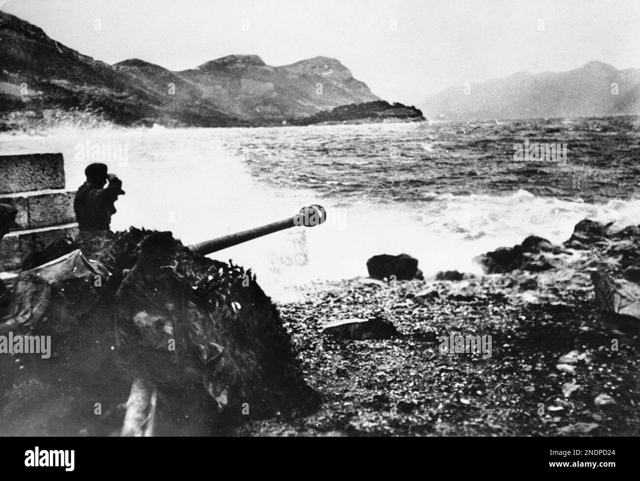 Constantly scanning the horizon with his binoculars, a German sentry ...