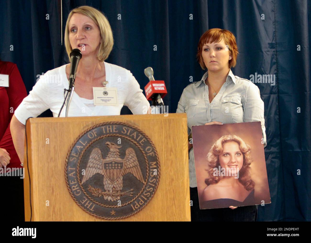 Kelli Belcher, niece of murder victim Rhonda Crane, holds a photograph of her aunt at 18, while ...