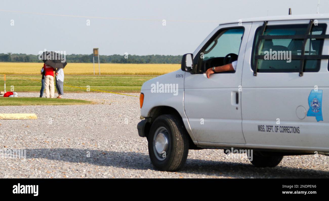 Prison guards watch as death penalty opponents gather on the grounds of ...