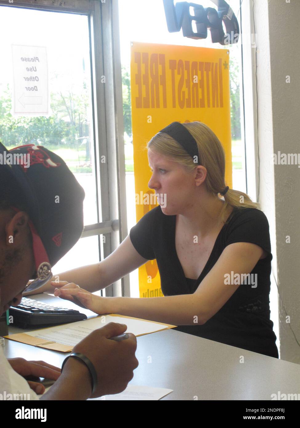 Sarah Lemanski, 24, manager of a Loan Max store, explains the terms of ...