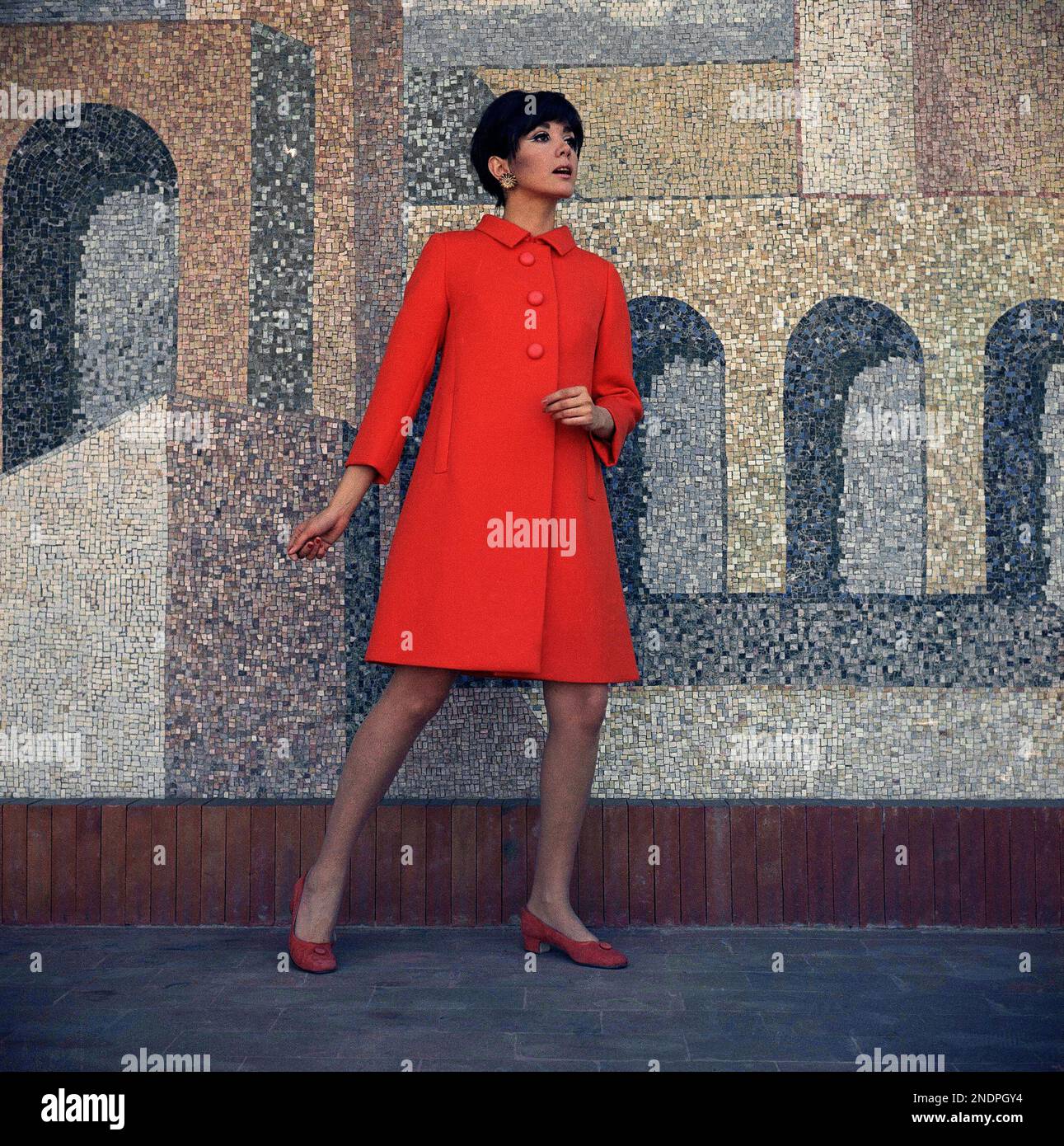 An orange-red woolen coat, by Renato Balestra fashion house of Rome ...