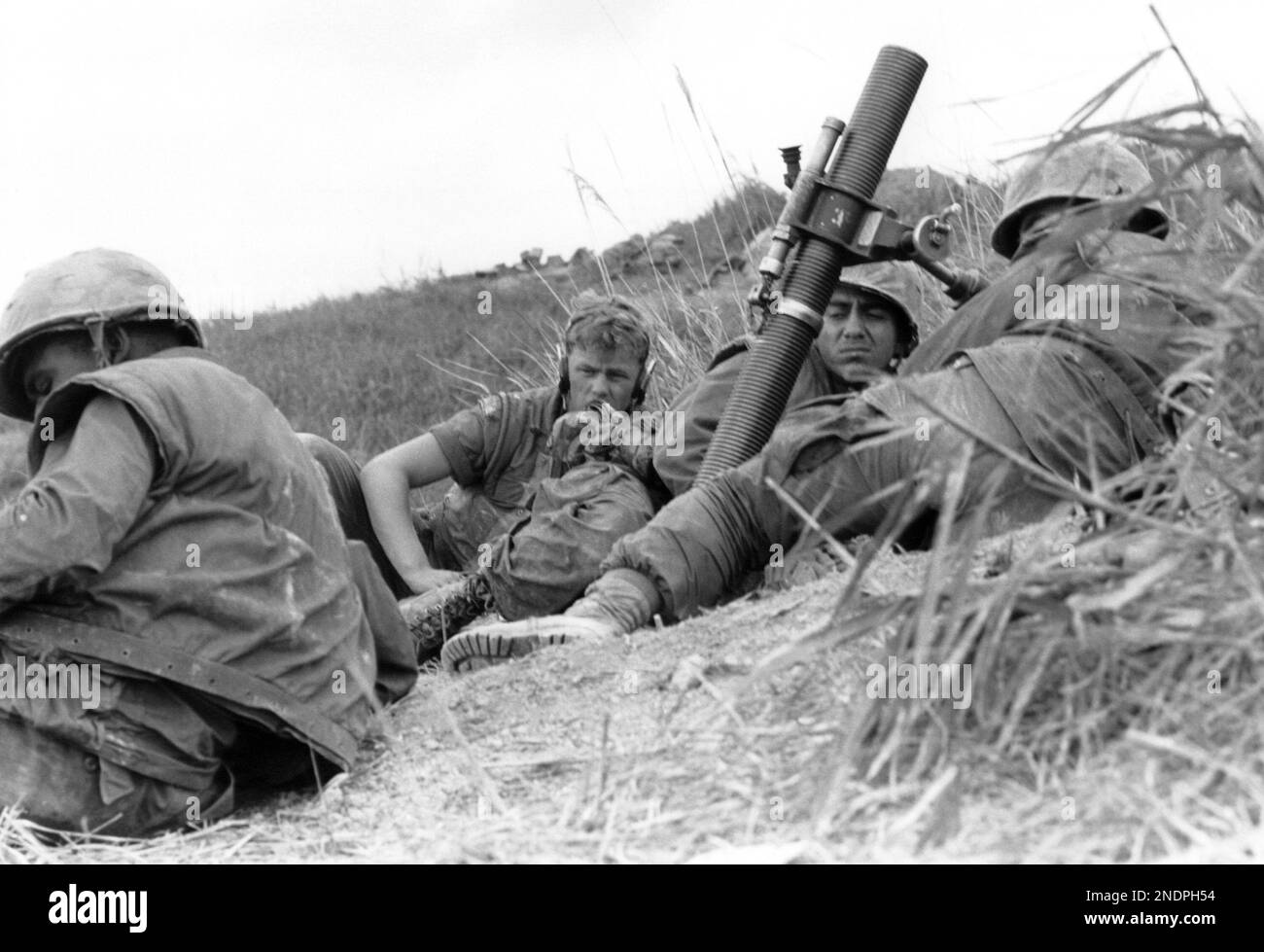 Two U.S. marines hug the ground in high grass on hill 162, position of ...