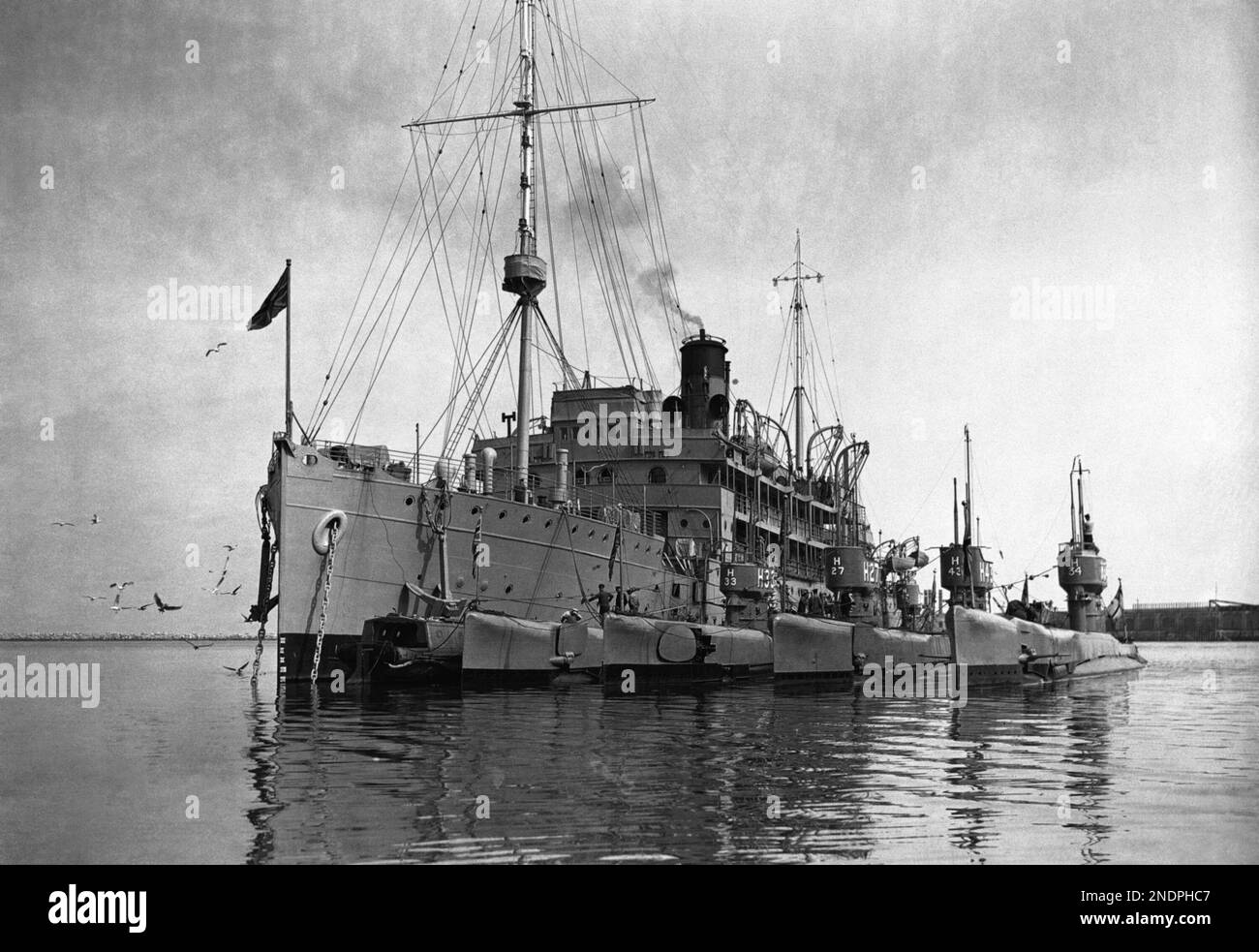 Submarine depot ship HMS Titania and submarines at Portland, England ...