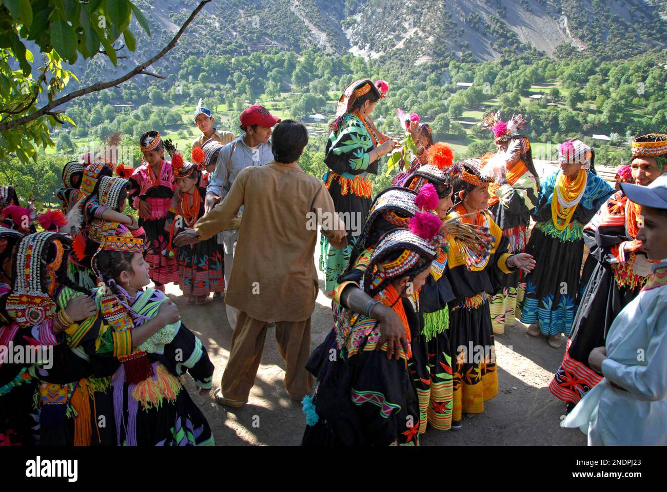 Pakistani Kalash girls clad in colorful traditional dresses dance in ...
