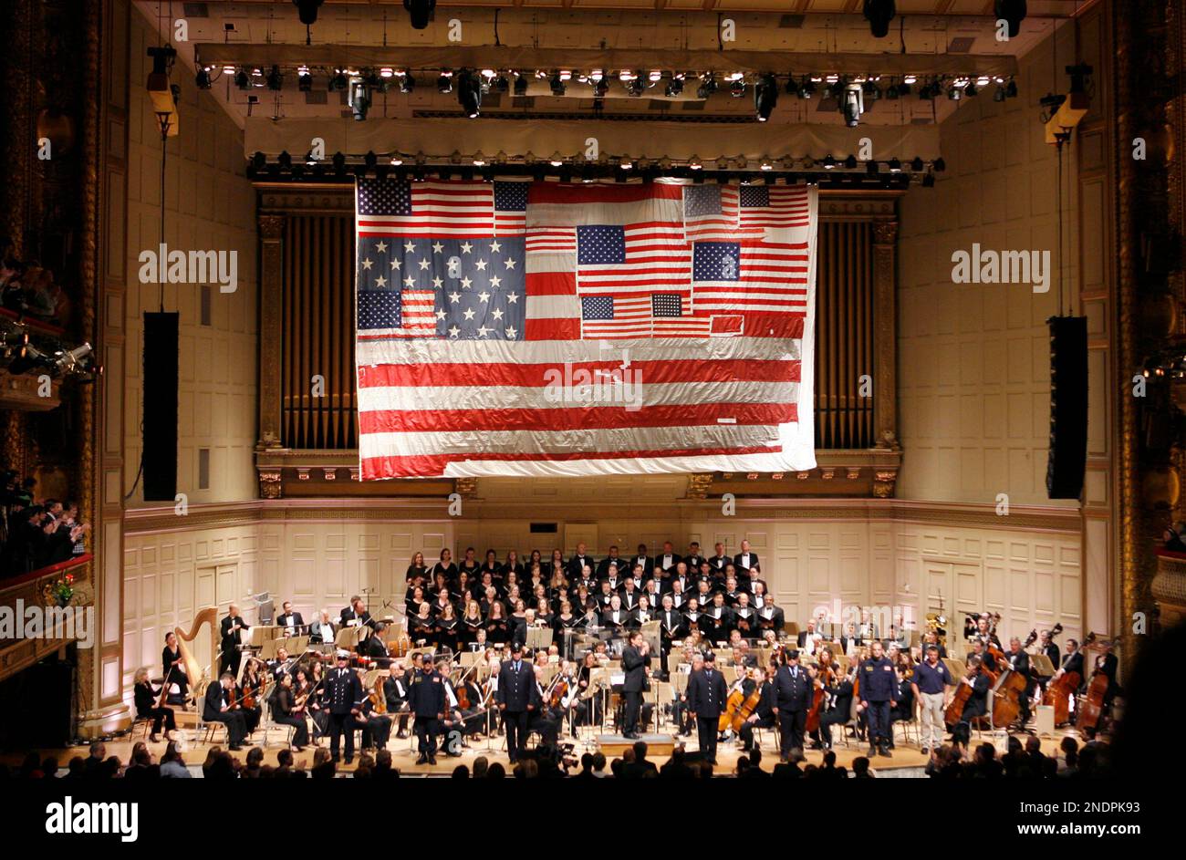 Members of the New York City and Boston Fire department line the stage ...