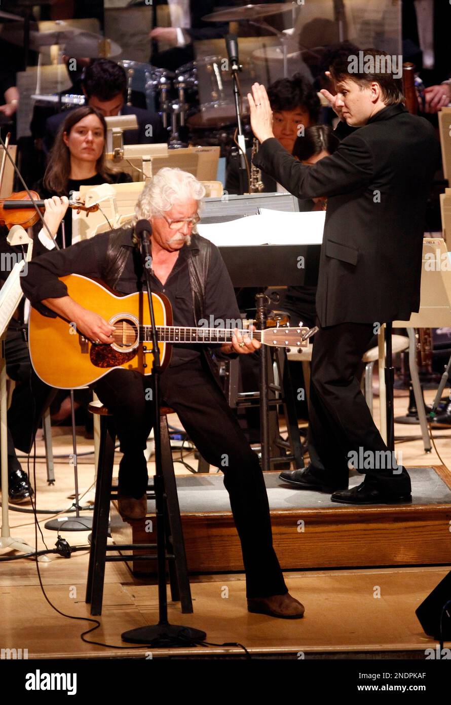 Arlo Guthrie, left, performs as Keith Lockhart leads the orchestra ...
