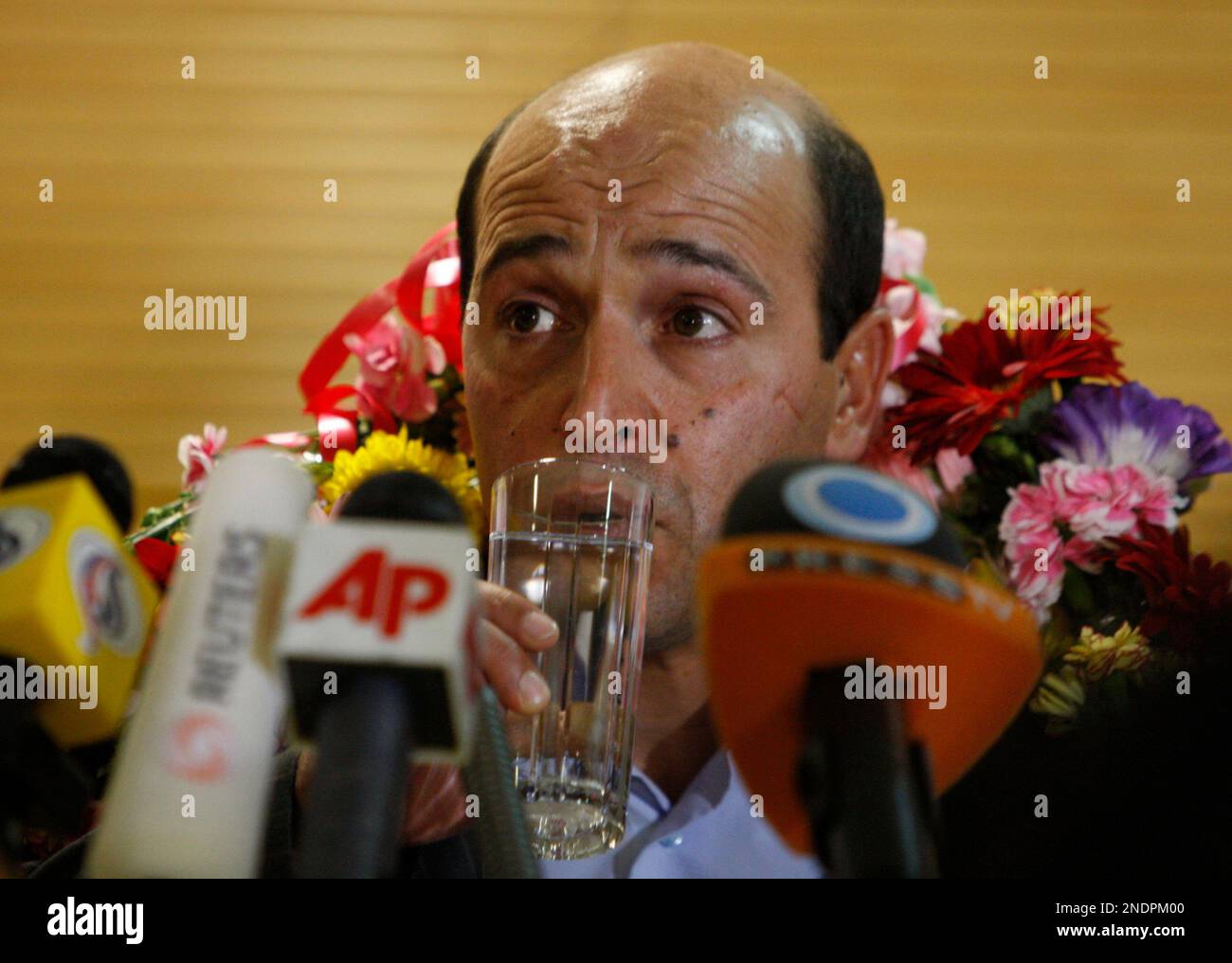Wearing a wreath of flowers, Ali Vakili Rad, who was convicted of ...