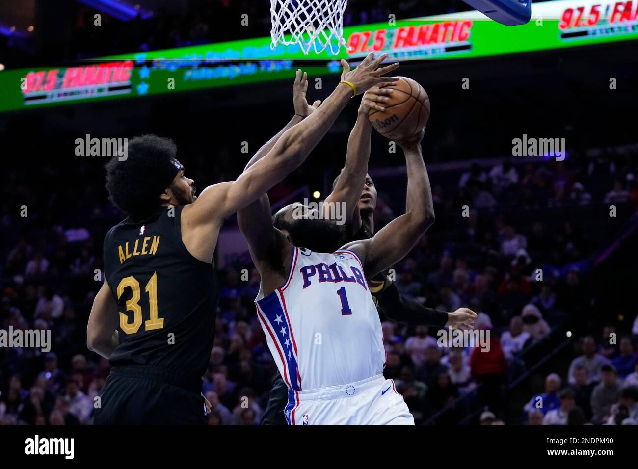 Philadelphia 76ers' James Harden, center, goes up fora shot between ...