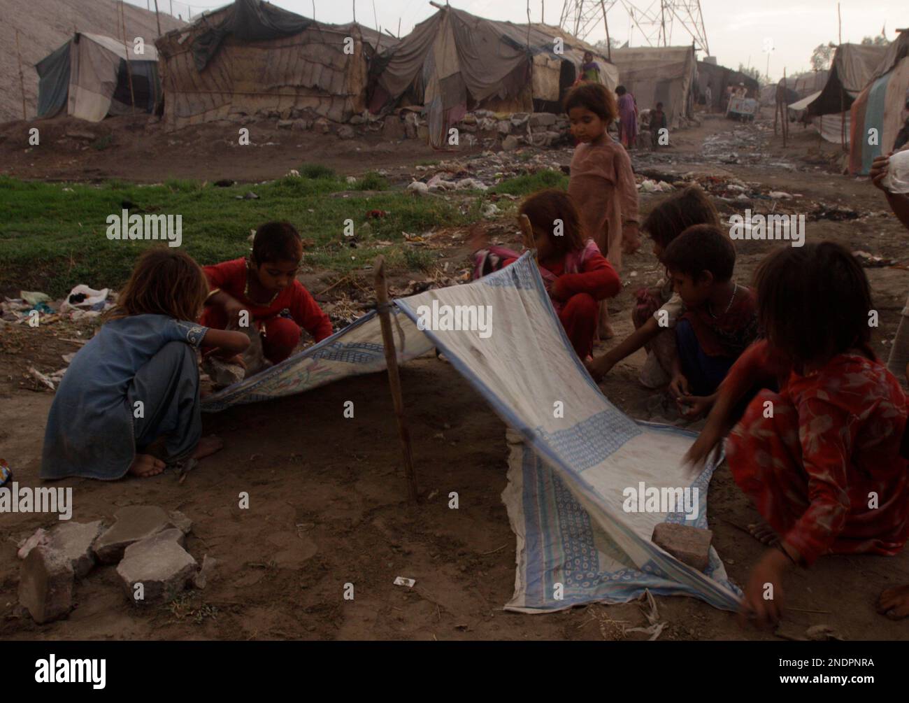 Pakistan children living in slums of Lahore in Pakistan fix their make ...