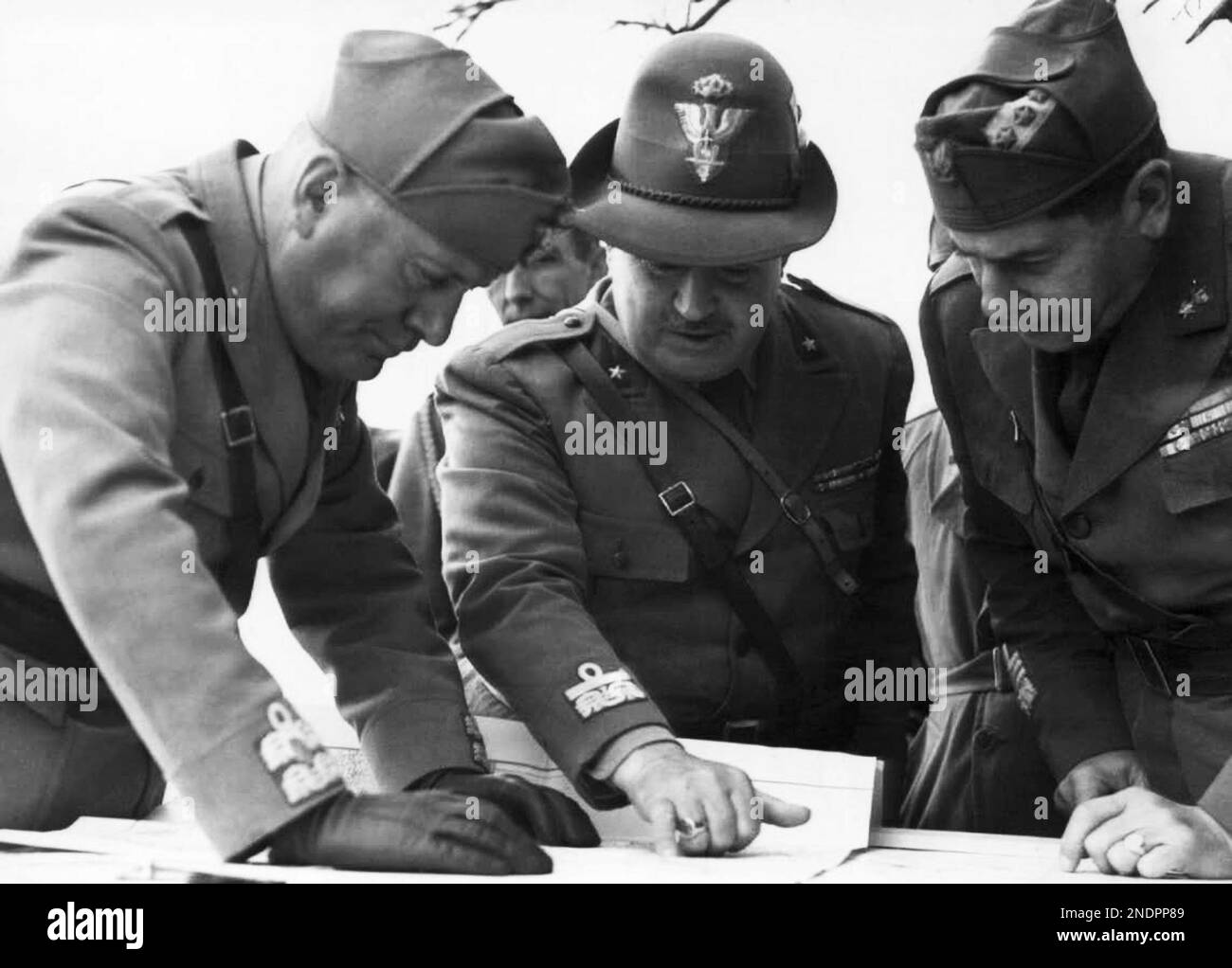 Italian Premier Benito Mussolini, left, studies a map with two of his ...