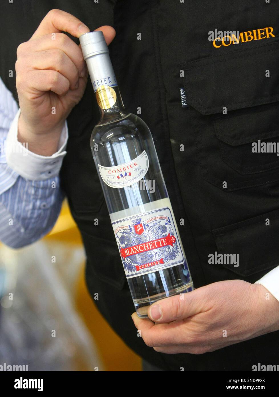 Am employee of the Combier distillery shows a bottle of absinthe in ...