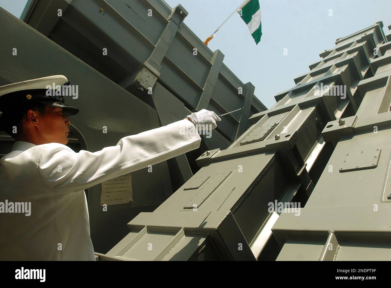 A sailor points to the homemade Hsiung-feng II missile launchers during ...