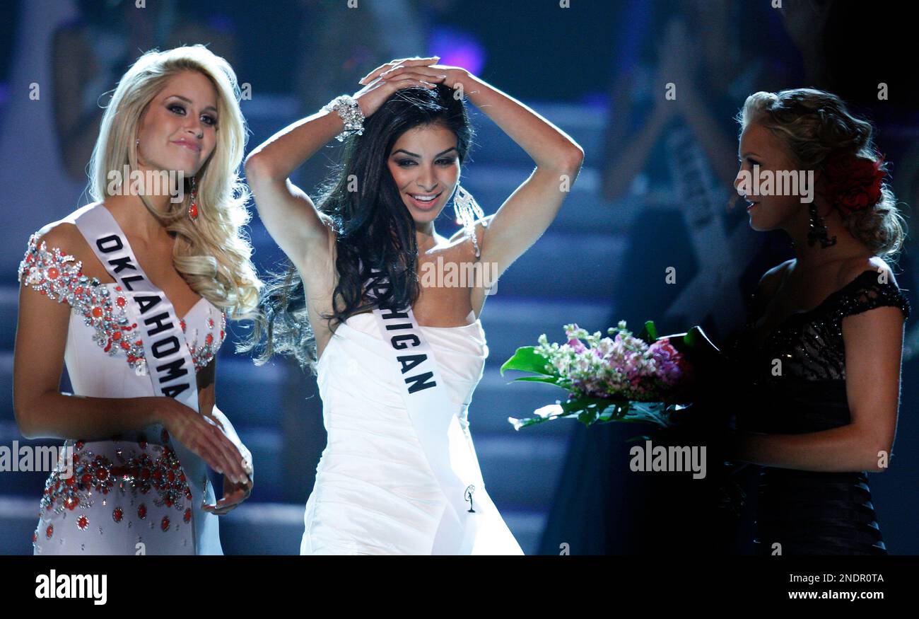 Miss Michigan Rima Fakih, center, reacts with first runner up Morgan ...