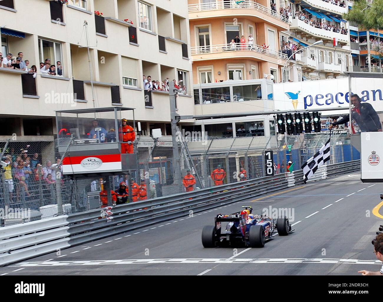 Red Bull driver Mark Webber of Australia crosses the finish line to win ...