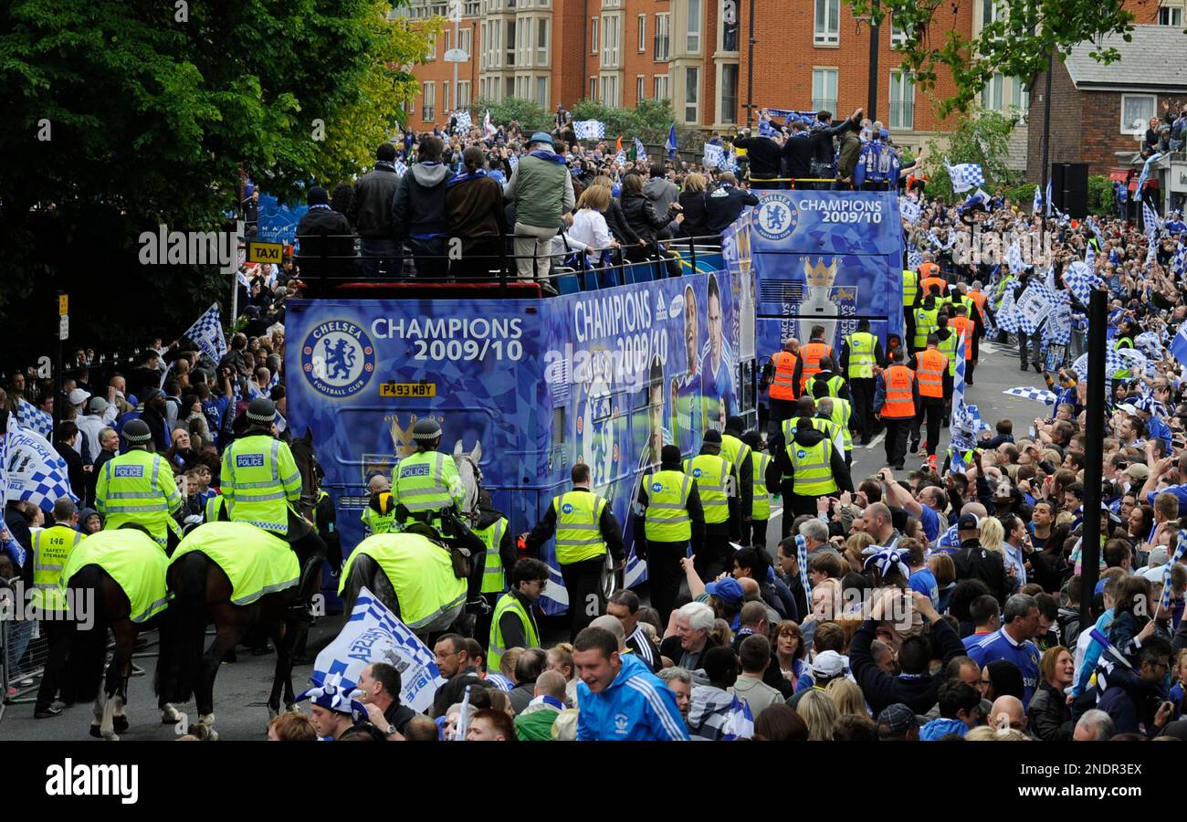 The Chelsea team buses during a victory parade, as fans line the ...