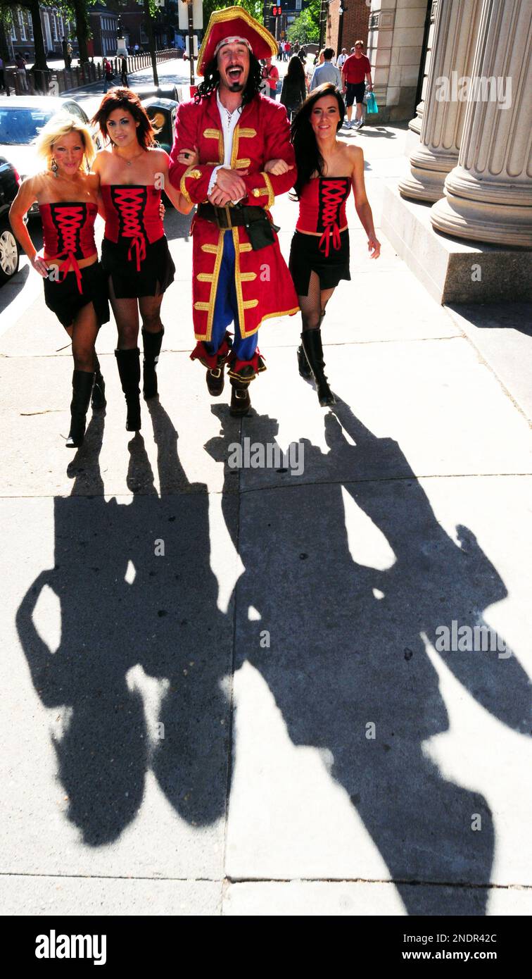 Captain Morgan and the Morganettes walk down the street as part of ...