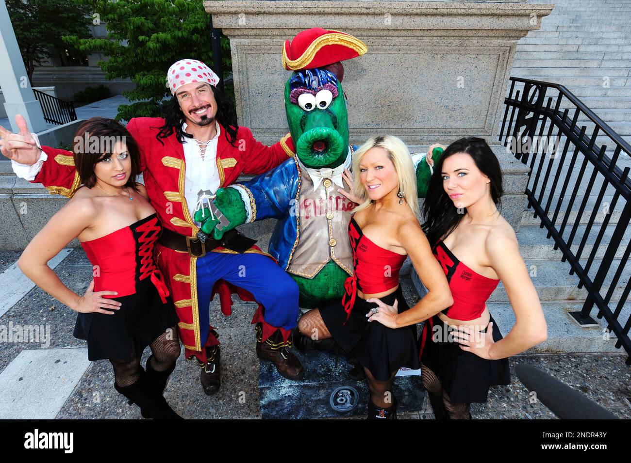 Captain Morgan and the Morganettes pose with a Phillies Fanatic statue ...