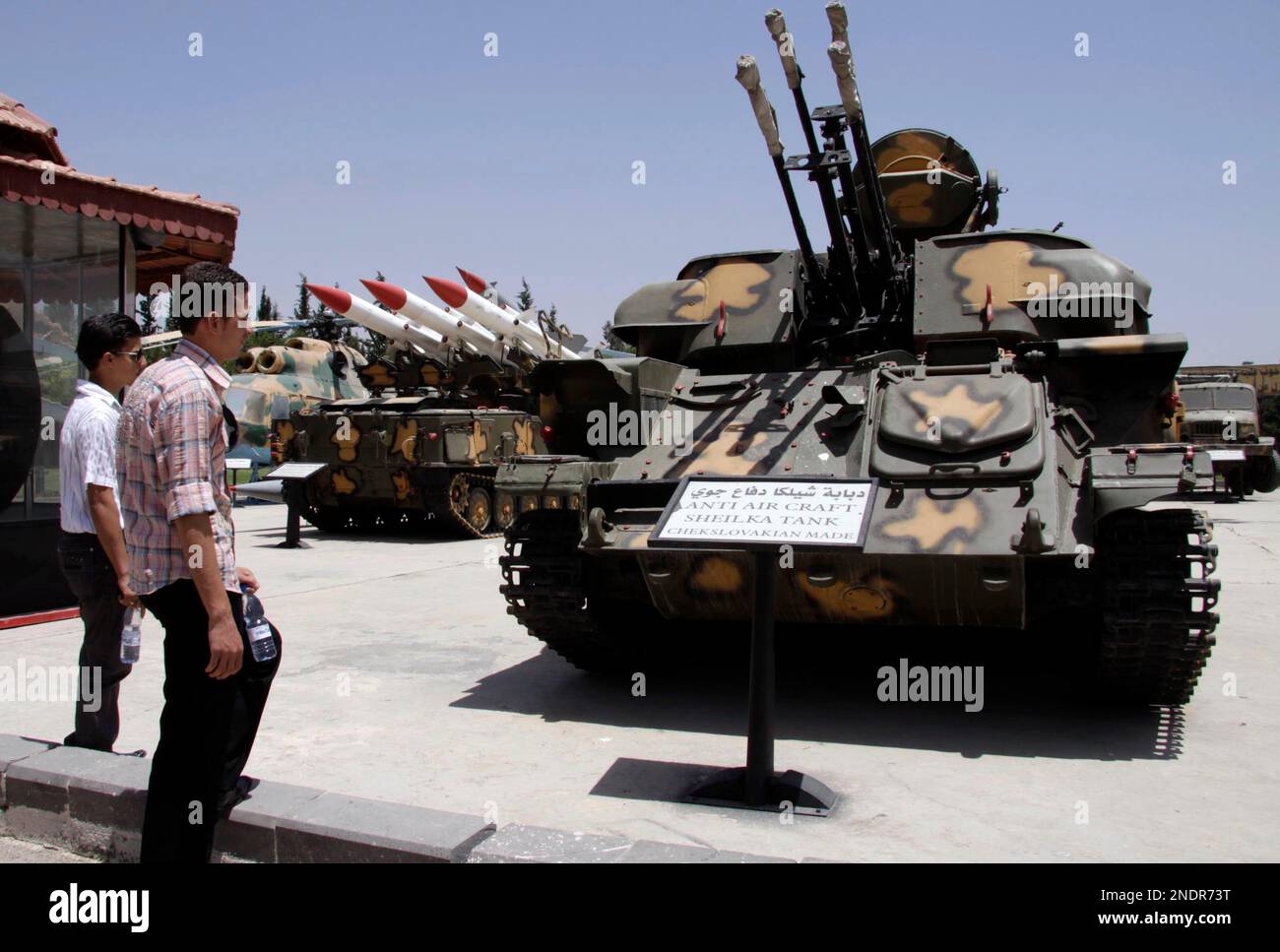 Syrians look at an Czechoslovakian-made tank which Syria used during ...