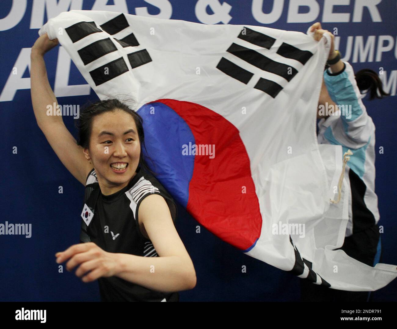 South Korea's Lee Kyung-won carries her national flag around the arena ...