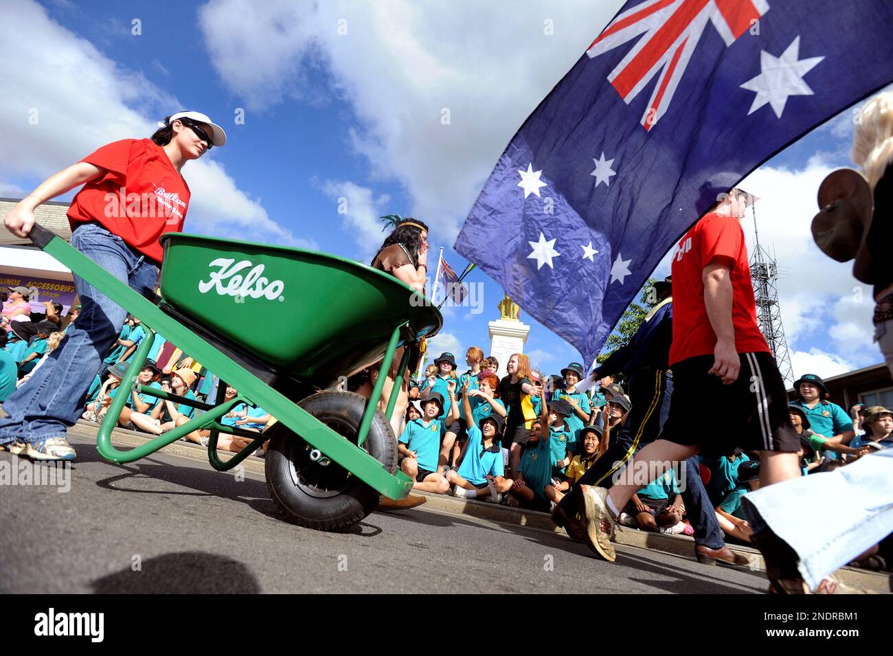 Competitors push their wheelbarrow during the parade at the start of ...