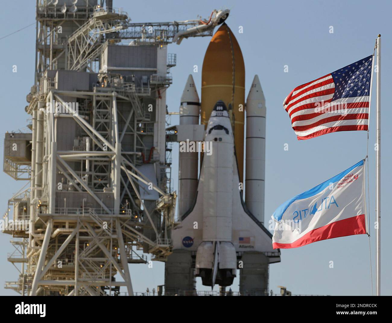 The United States and mission flags wave as the rotating service ...