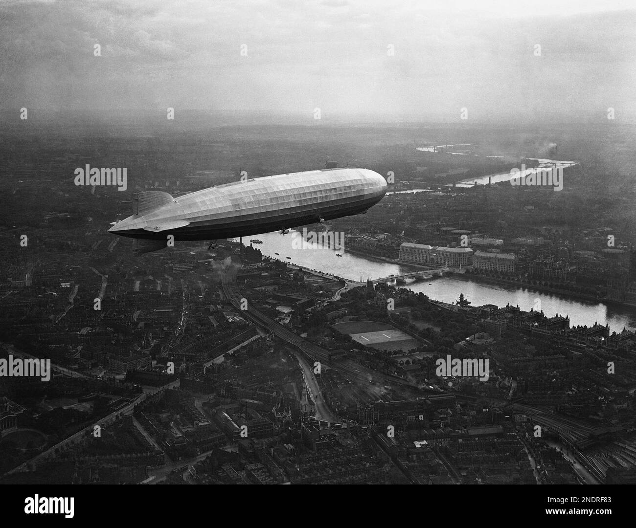 German airship Graf Zeppelin over London with plane below on July 2 ...