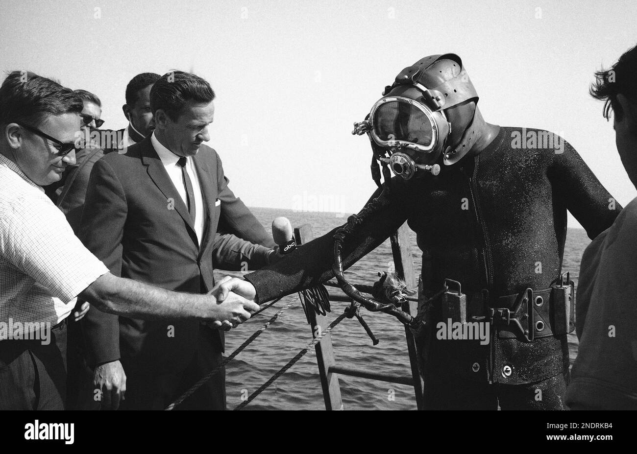 Donald G. Agger, left, of U.S. department of transportation, reaches ...