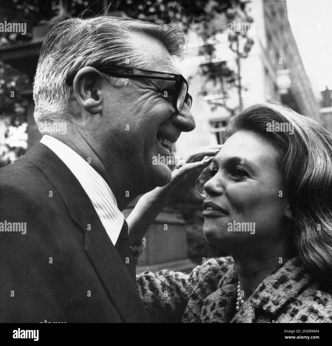 Cary Grant and his wife Dyan, 28, are seen during a stroll through the embankment gardens ...