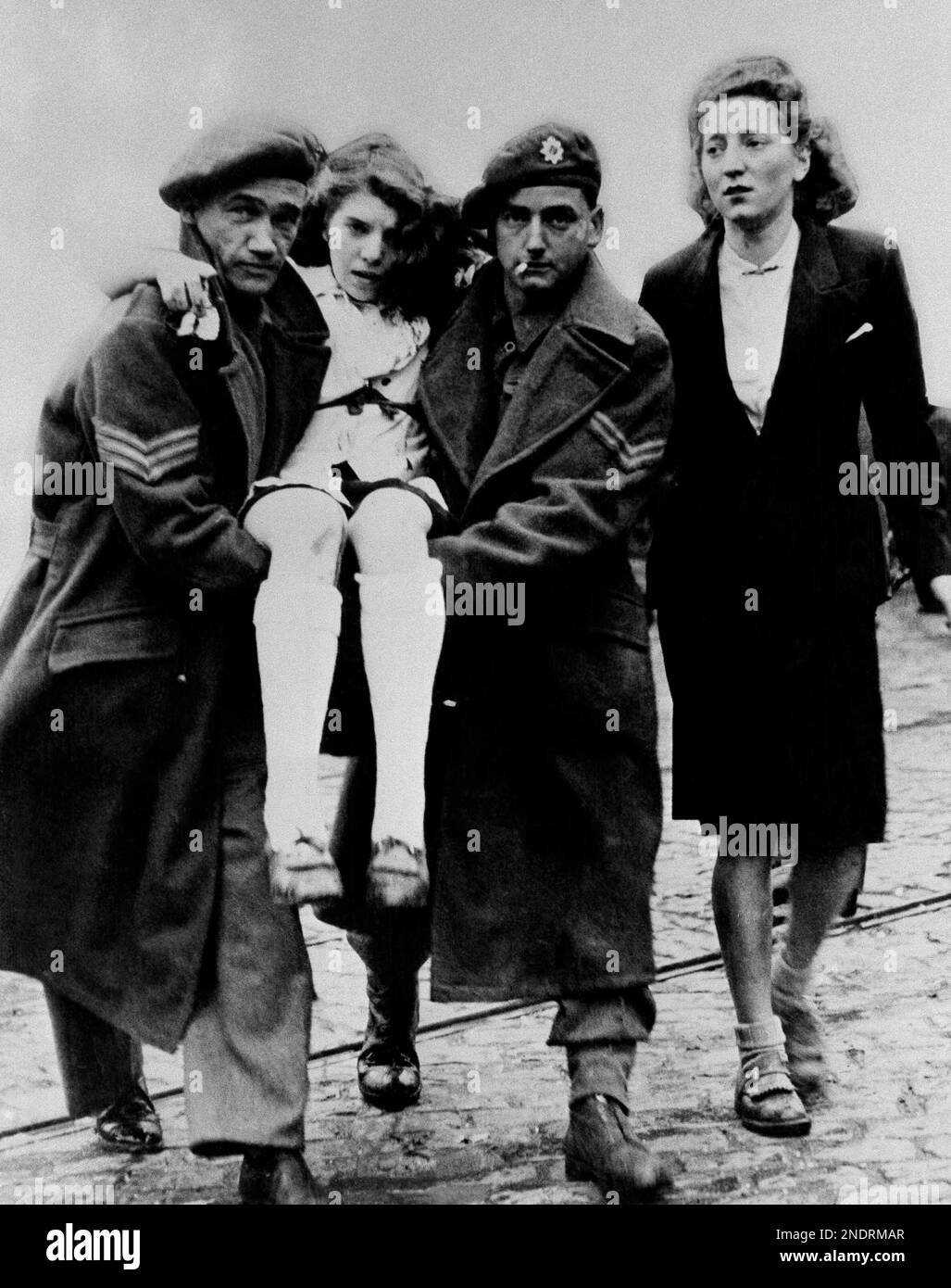 Allied soldiers carry a child from the scene of a German V bomb ...