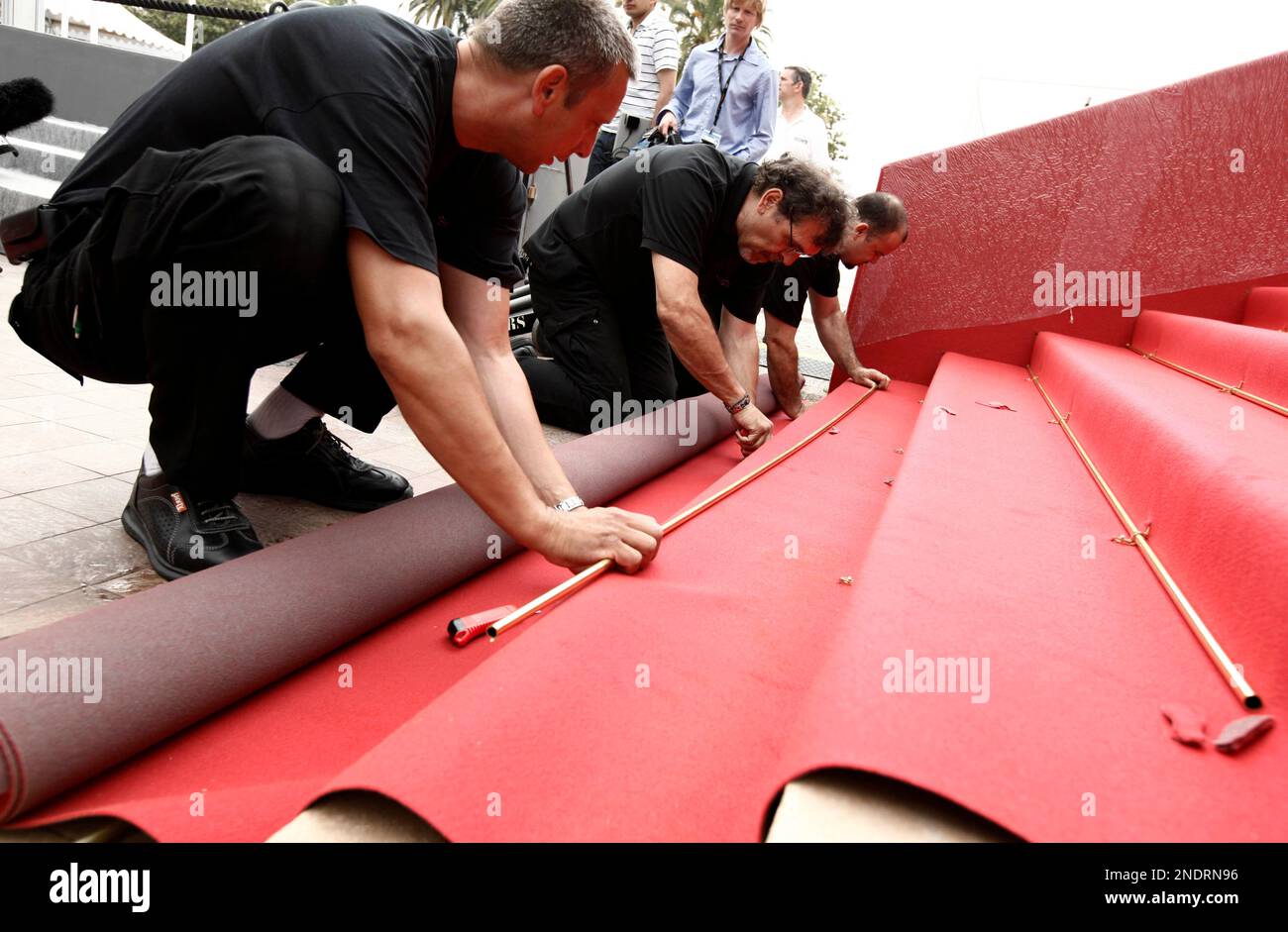 Workers prepare the red carpet on the steps of the Palais prior to the ...