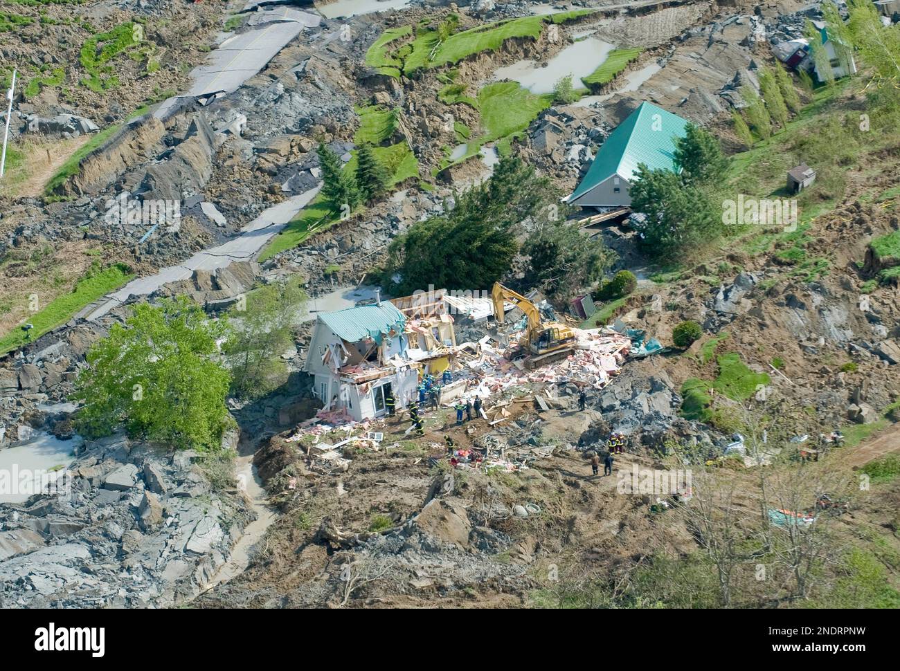 Rescuers work at the scene of a landslide in Saint-Jude, Quebec as ...