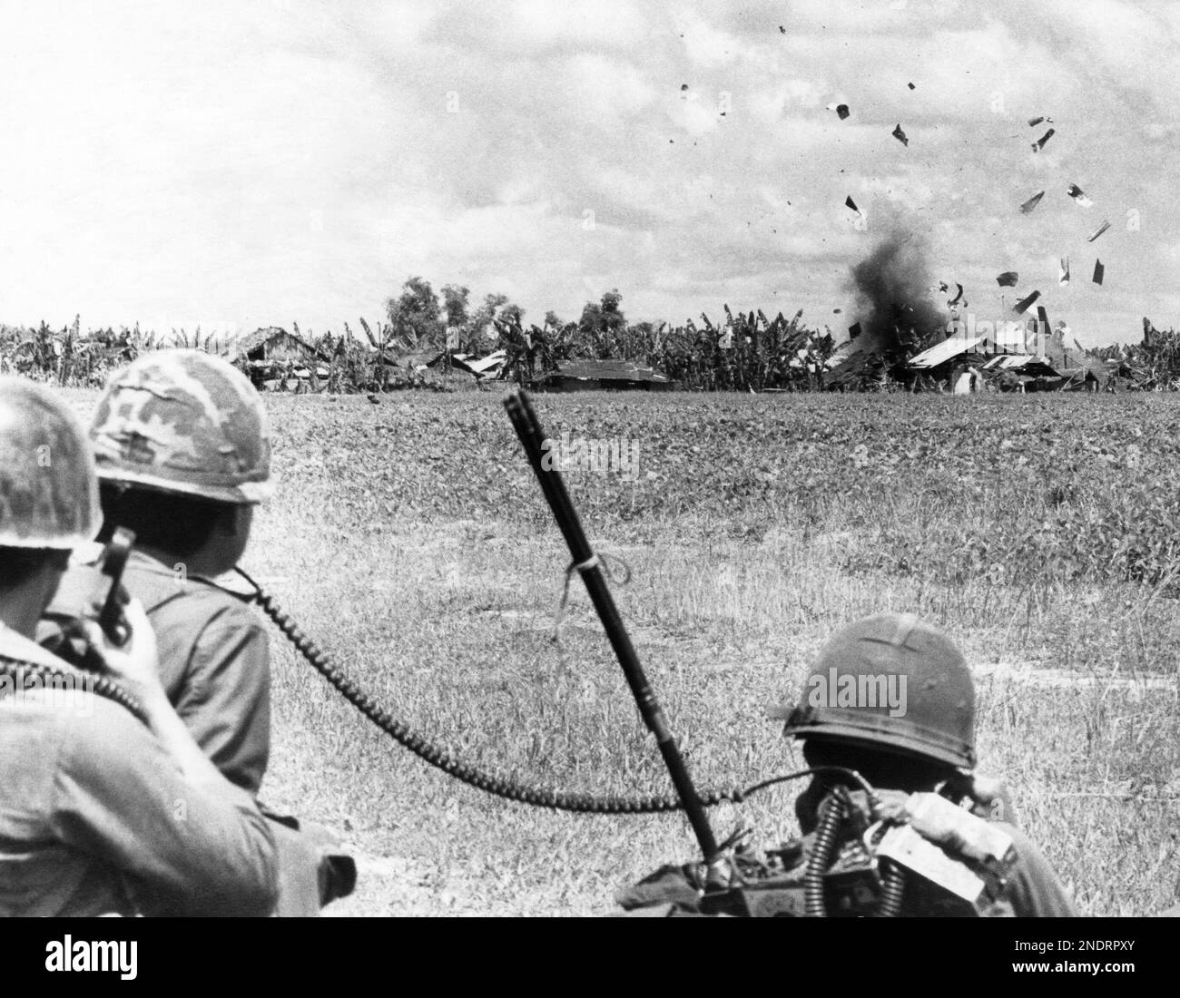 South Vietnamese soldiers, foreground, watch as a recoiless rifle shell ...