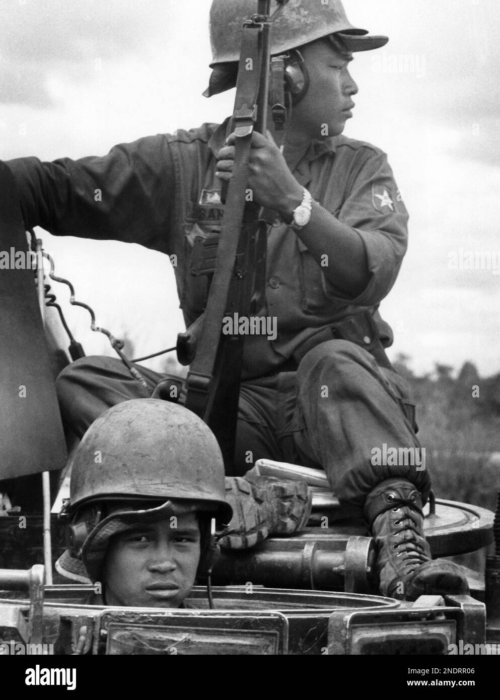 The South Vietnamese crew of a personnel carrier sits atop their ...