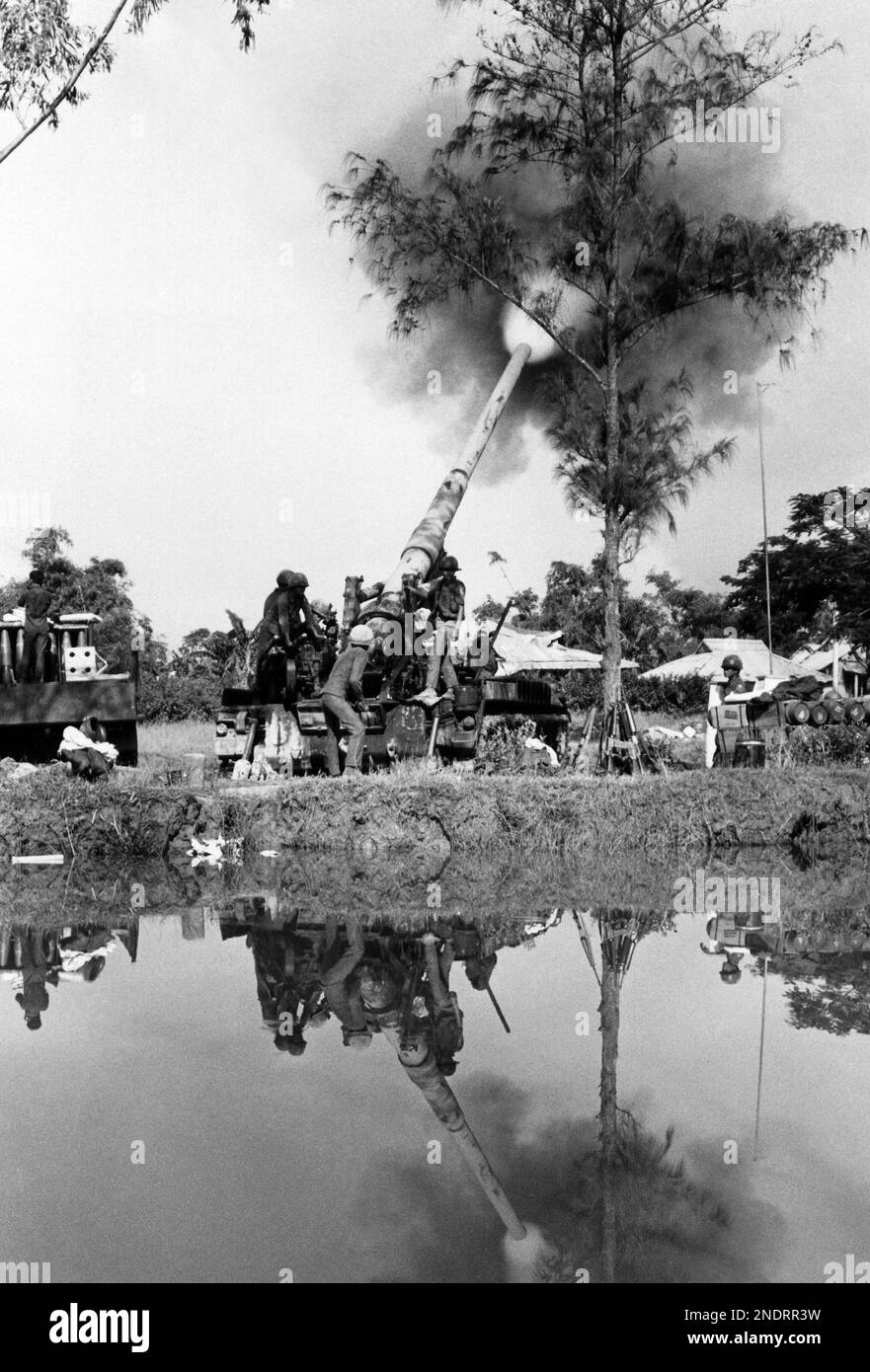 The blast of a South Vietnamese 175 mm gun is reflected in a pool at an ...