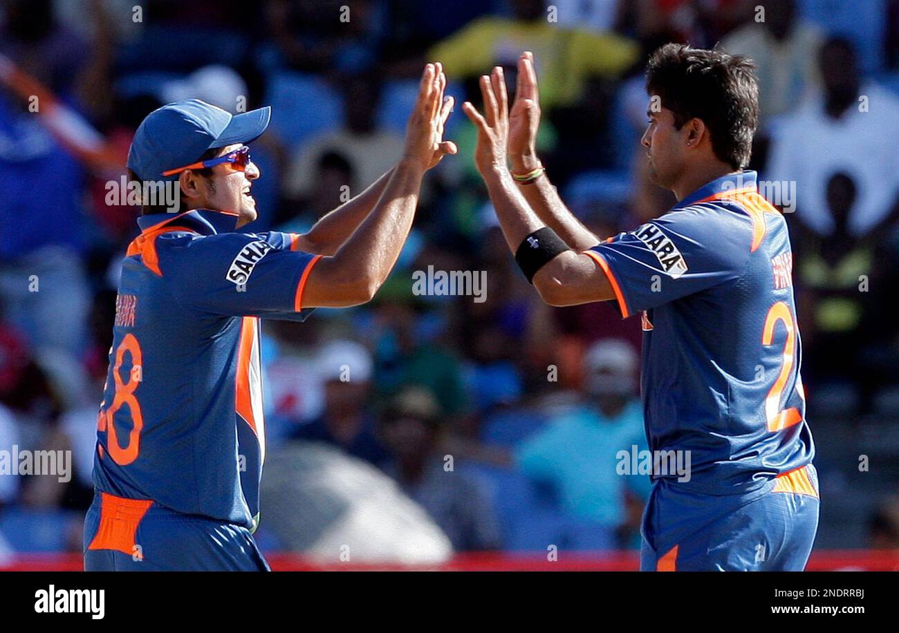 India's bowler Vinay Kumar, right, high fives teammate Suresh Raina ...