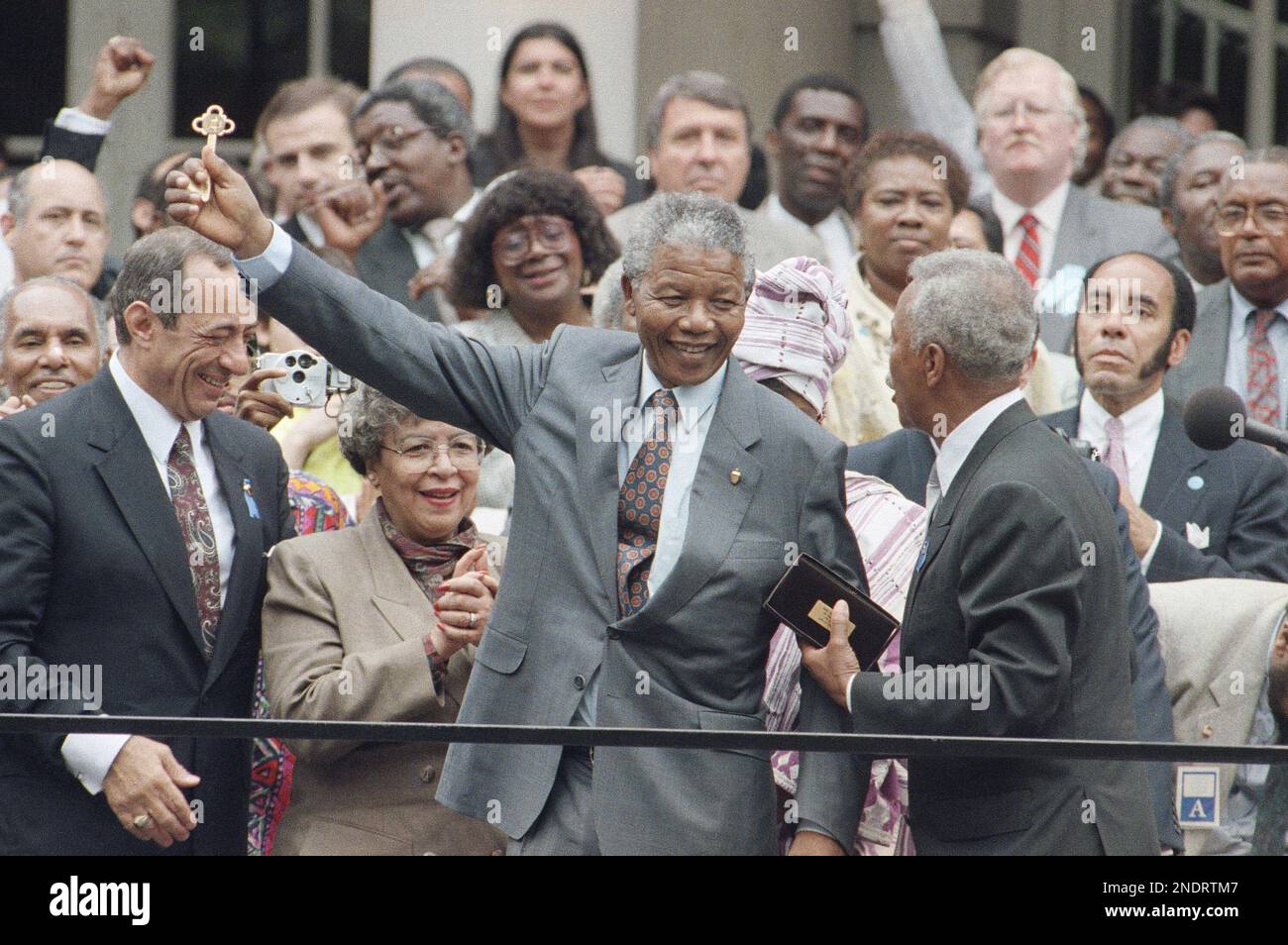 Nelson Mandela, center, is flanked by New York Governor Mario Cuomo ...