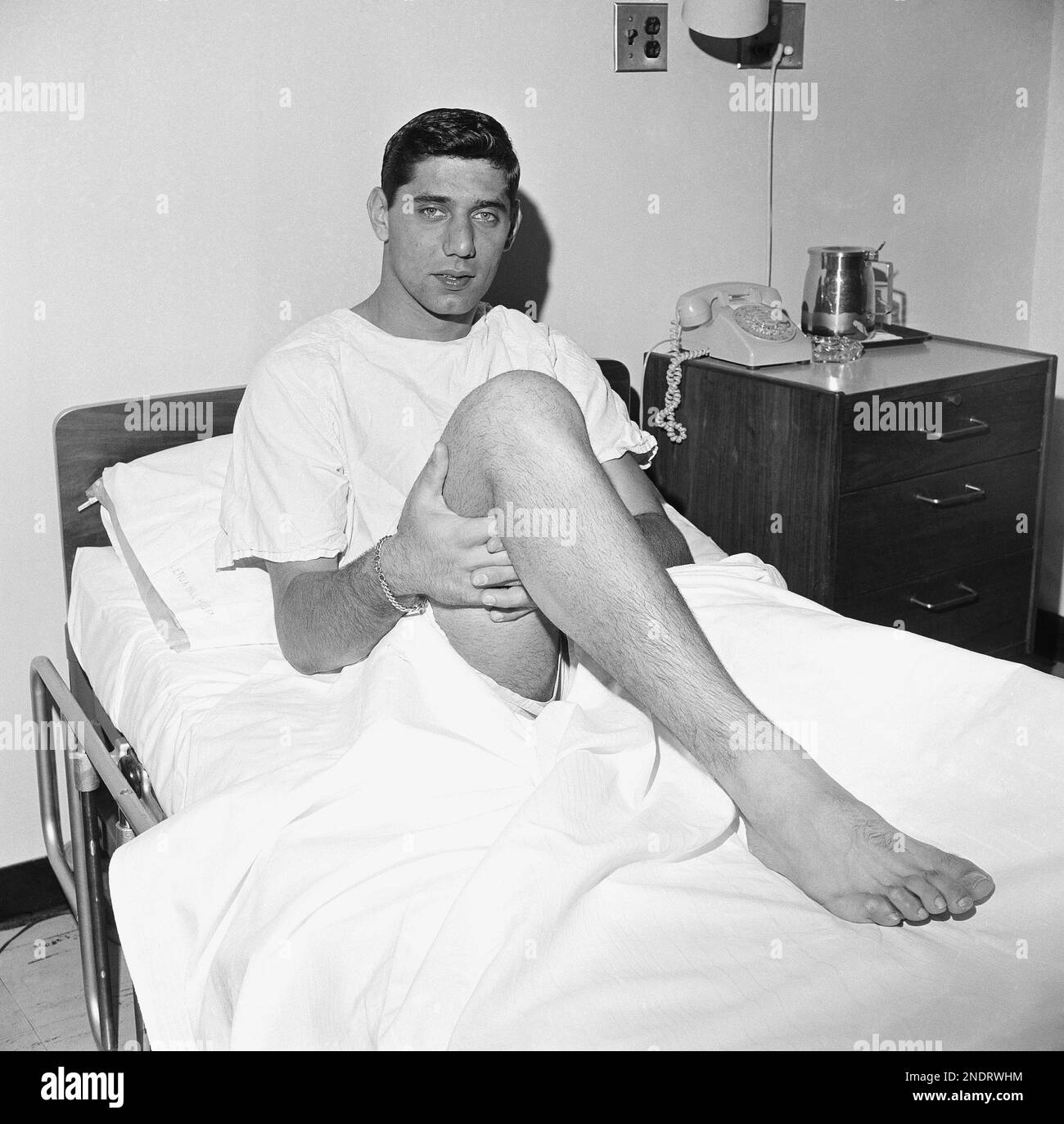 Joe Namath, recently signed by the New York jets, holds his knee in New ...