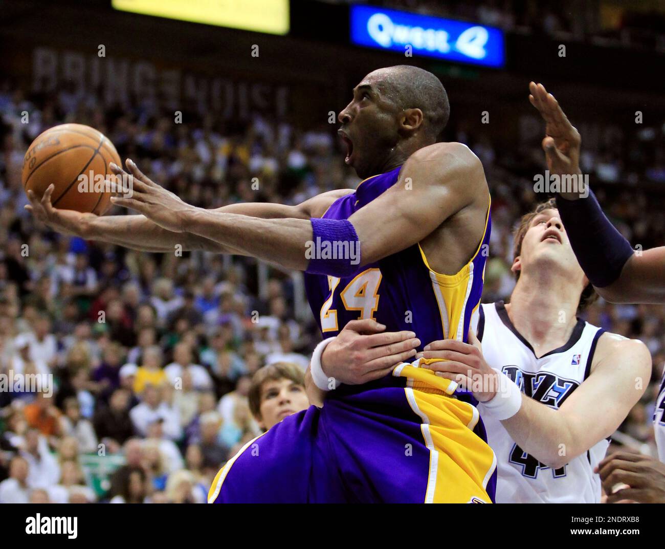 Los Angeles Lakers guard Kobe Bryant (24) is held by Utah Jazz center ...