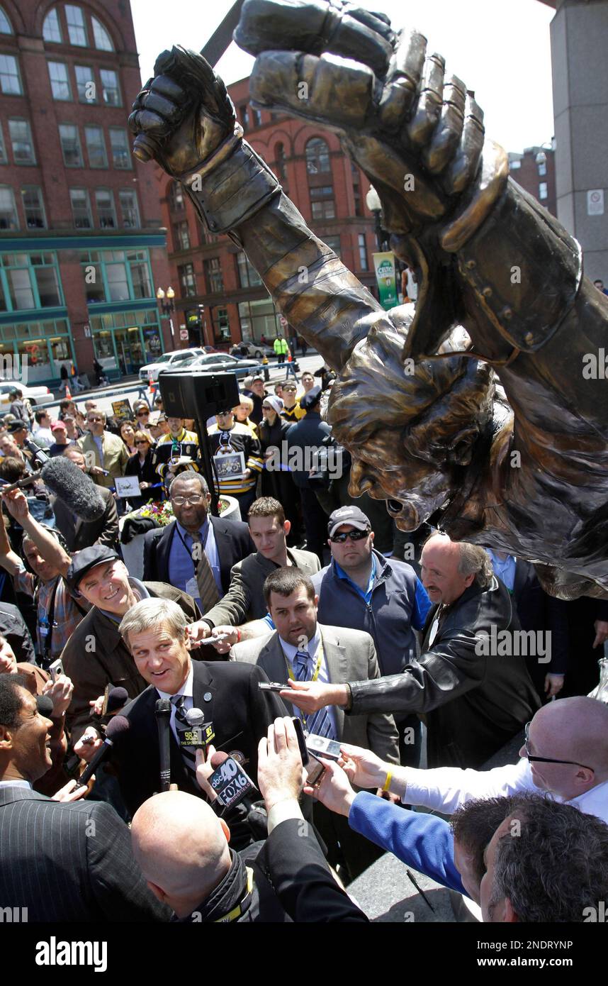 Boston Bruins hockey great Bobby Orr, center left, is surrounded by ...